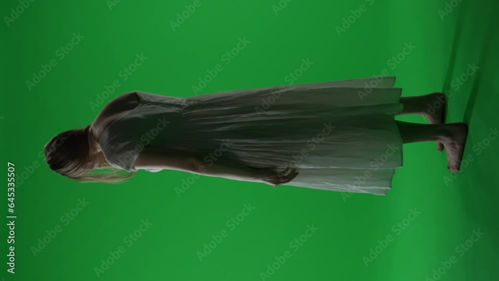 Full-size vertical green screen, chroma key video of a posessed female ...