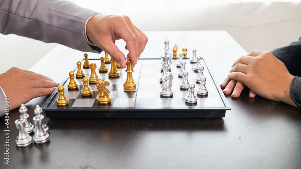 Young businessman planning winning chess move in game of chess ...