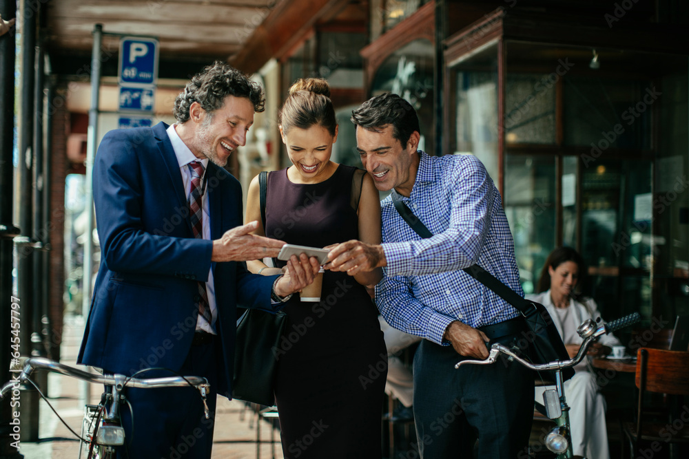 Diverse group of coworkers using a smartphone while commuting together ...