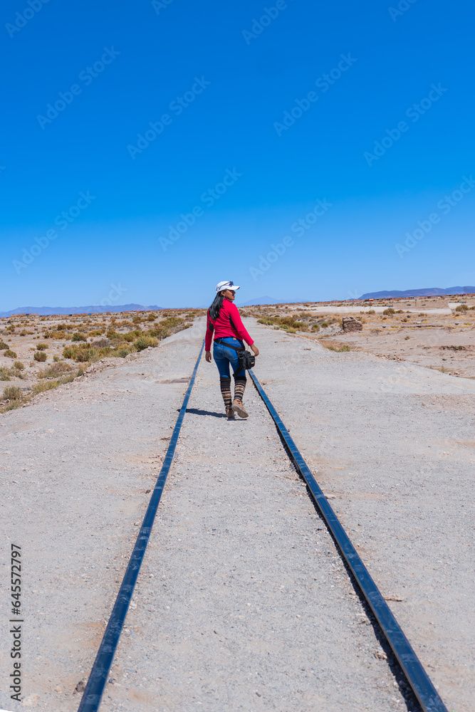 Fashion meets nature: young woman in a red outfit in the Uyuni, Bolivia ...