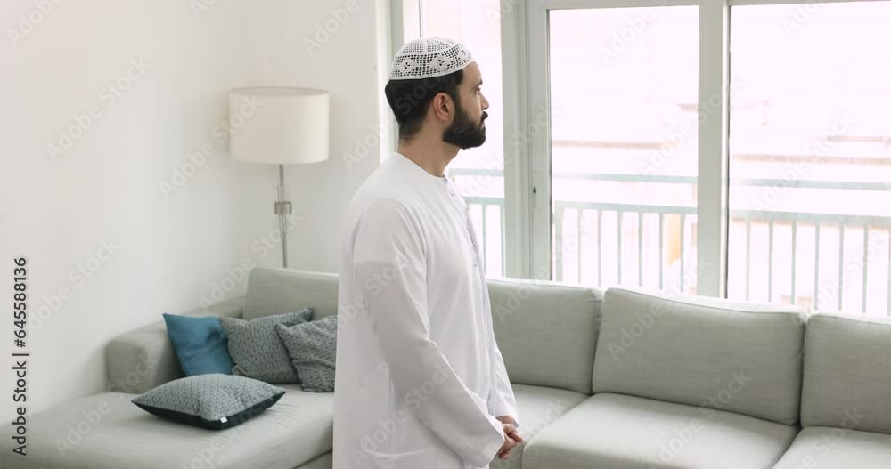 Silent middle-aged Muslim man wear white traditional kandura clothes ...