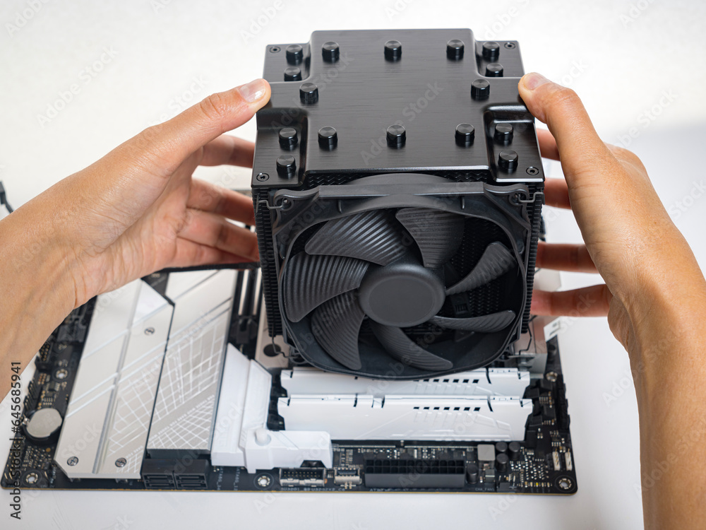 Installing a large air cooler on a computer processor. Stock Photo ...