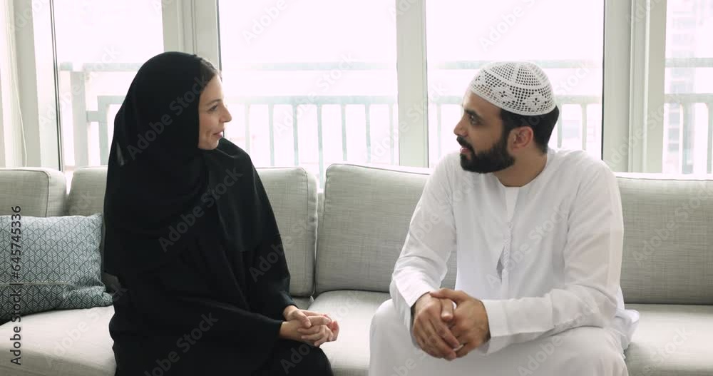 Arabian couple in traditional Muslim garment, wife in hijab husband in ...