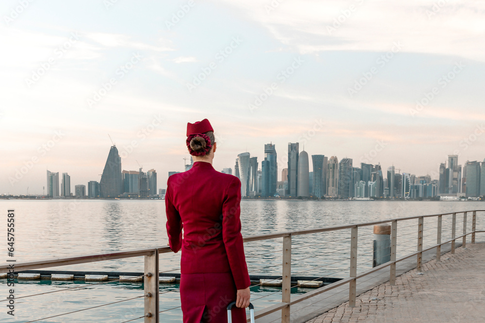View from the back at unrecognisable Qatar Airways cabin crew, walking ...
