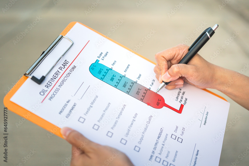 Action of a chemical engineer is using the pen to checking on oil ...