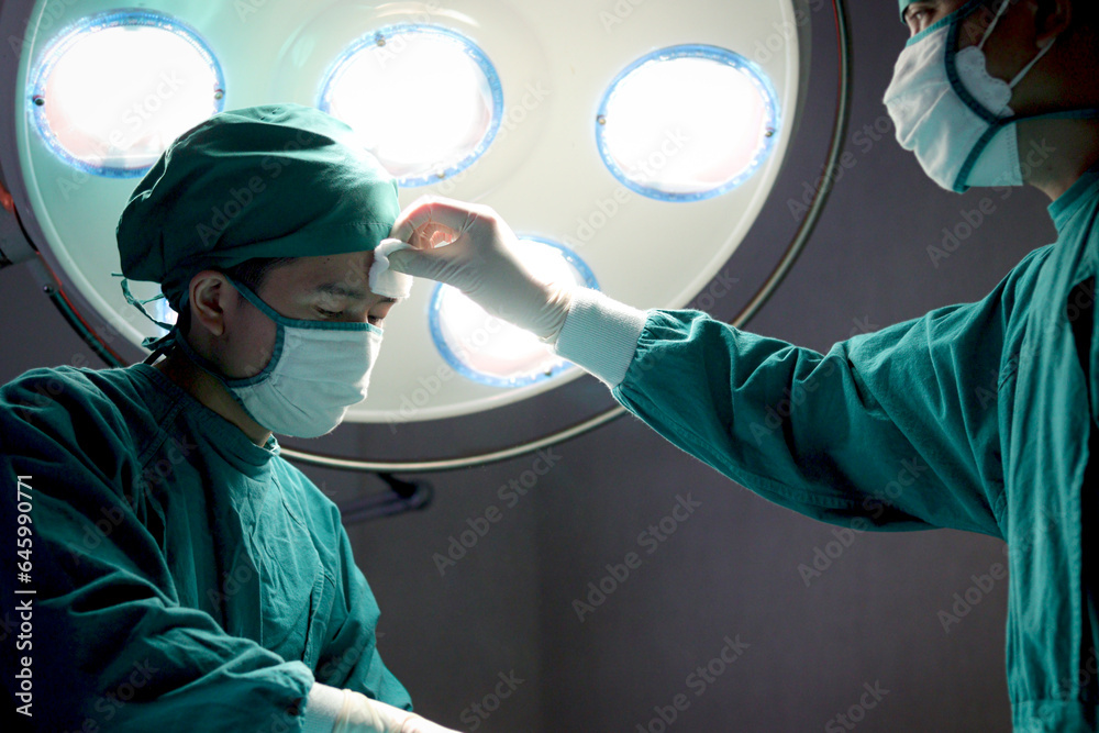 Professional surgical team operating surgery patient, medical staff ...