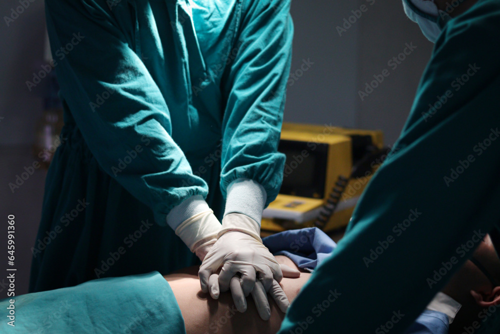 Surgeon doctor hand performing CPR pump chest on heart attack patient to save life sick people ...