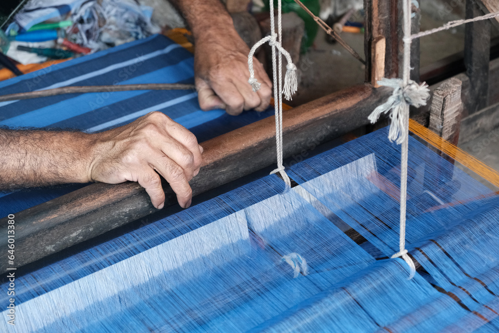 Weaver weaving traditional lungi by handloom at Joypara, a village in ...