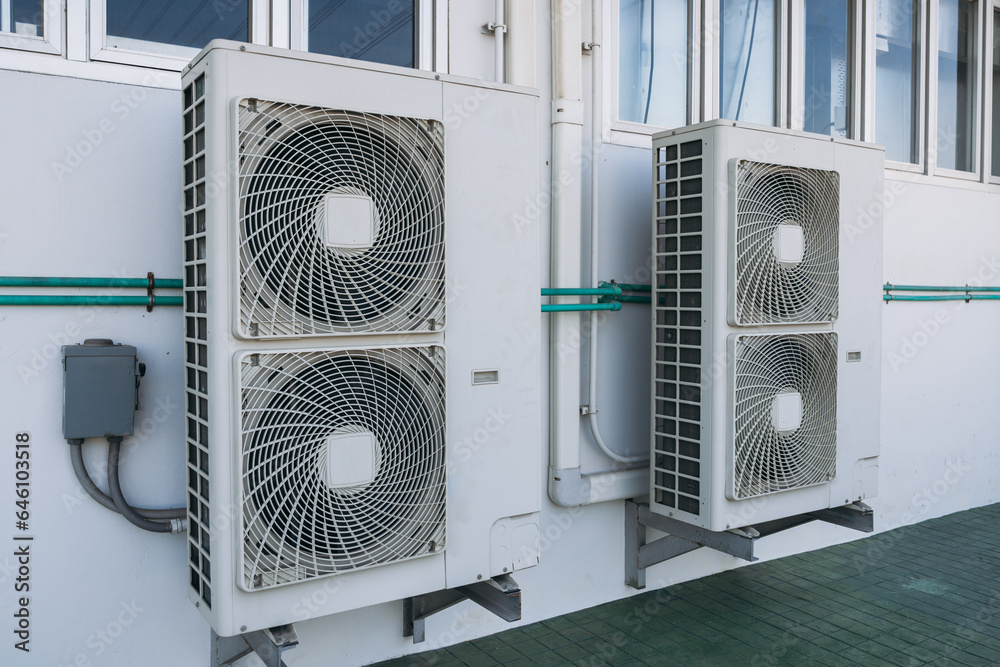 Air conditioner compressor installed on the roof of a building, along ...