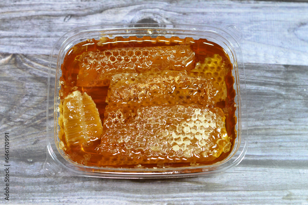 Hexagonal honeycomb cells with honey that hold the queen bee's eggs and ...