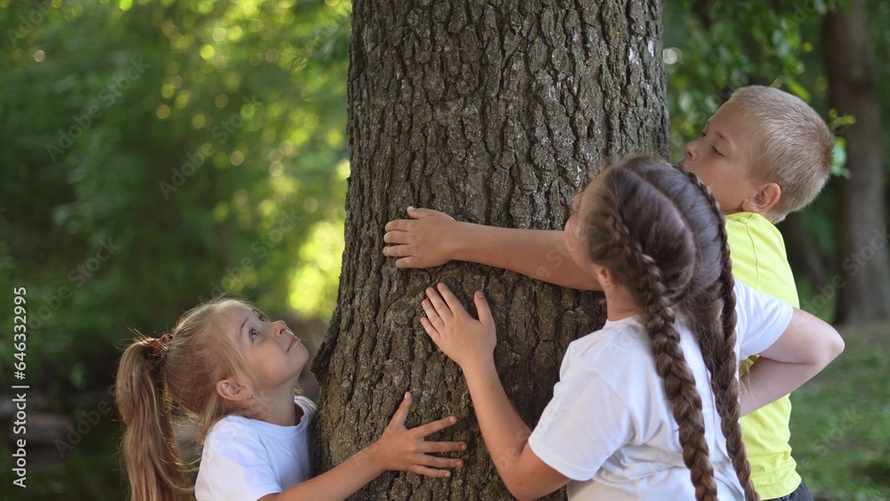 children hugging a tree in the forest. happy family childhood dream ...