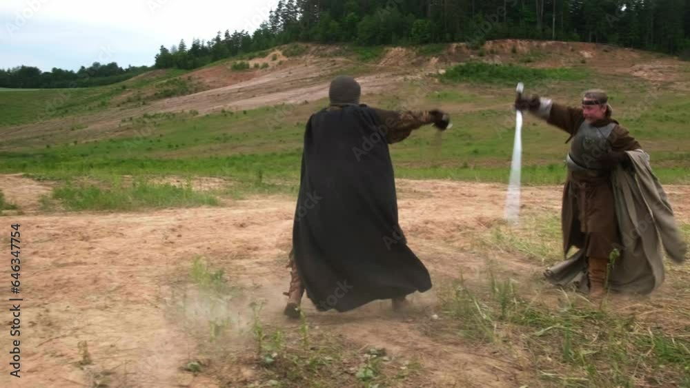 two warriors fight with swords, two knights fight with swords, two men ...