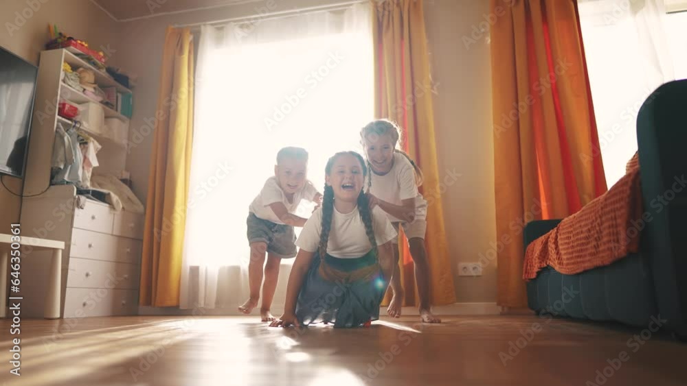 small children play at home and ride a skateboard. happy family ...