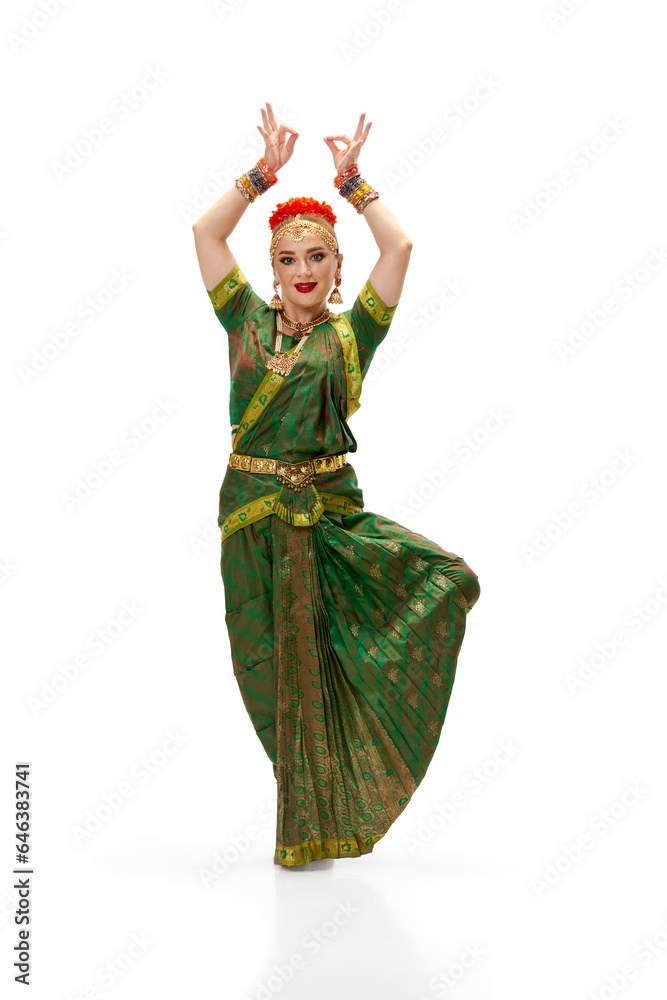 Beautiful, elegant, young woman in traditional indian dress dancing ...