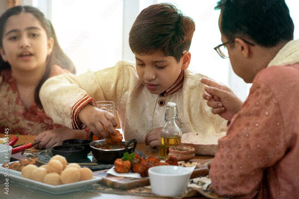 Stockfoto Indian boy in traditional cloth enjoy eating with Indian ...