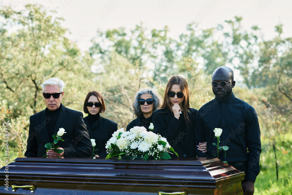 Group of intercultural grieving people in mourning attire and ...