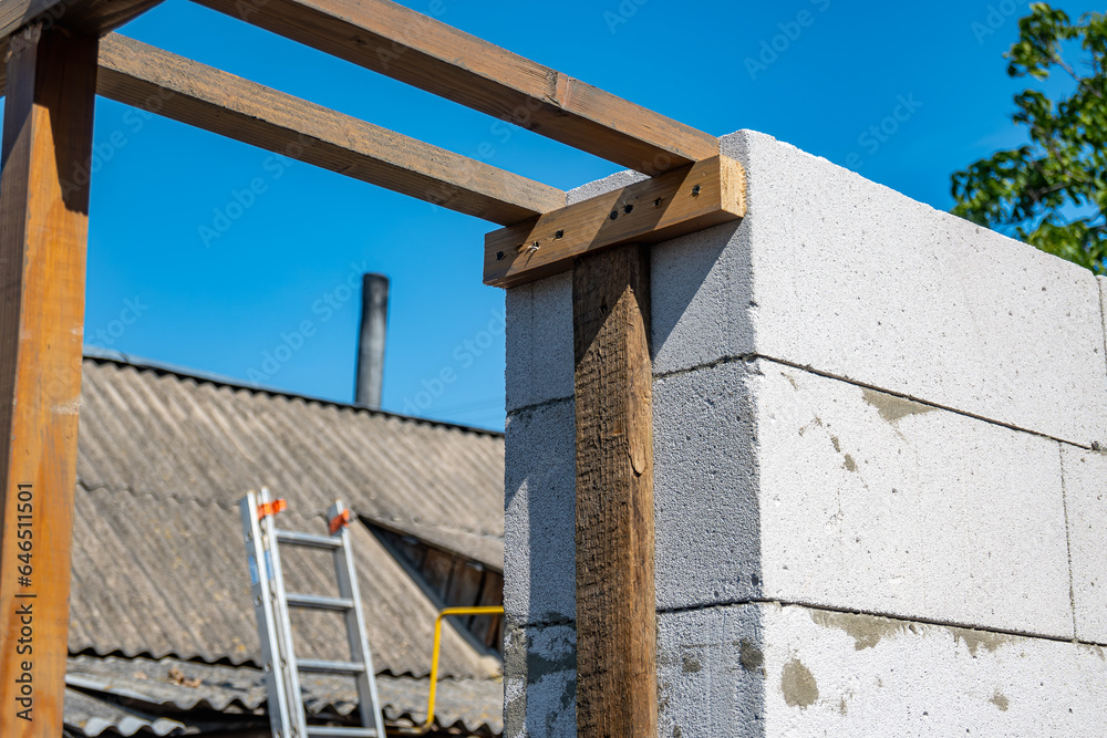 An erected wall with a window opening made of white aerated concrete ...