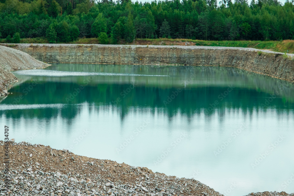 This is a former shale quarry with azure water and picturesque hills ...