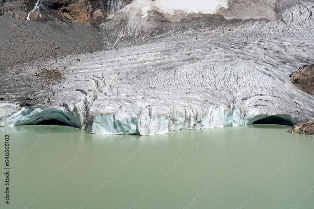 Mountain glacier melting into the lake. ice crevasses and caves. Global ...