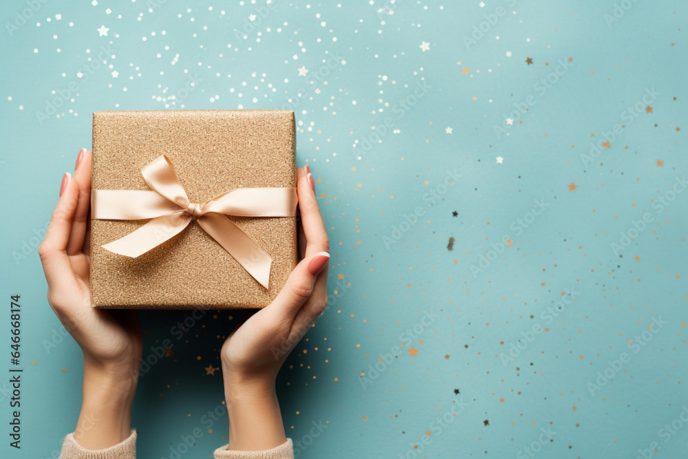 The photo shoot of a woman hands holding a wrapped gift box by paper ...