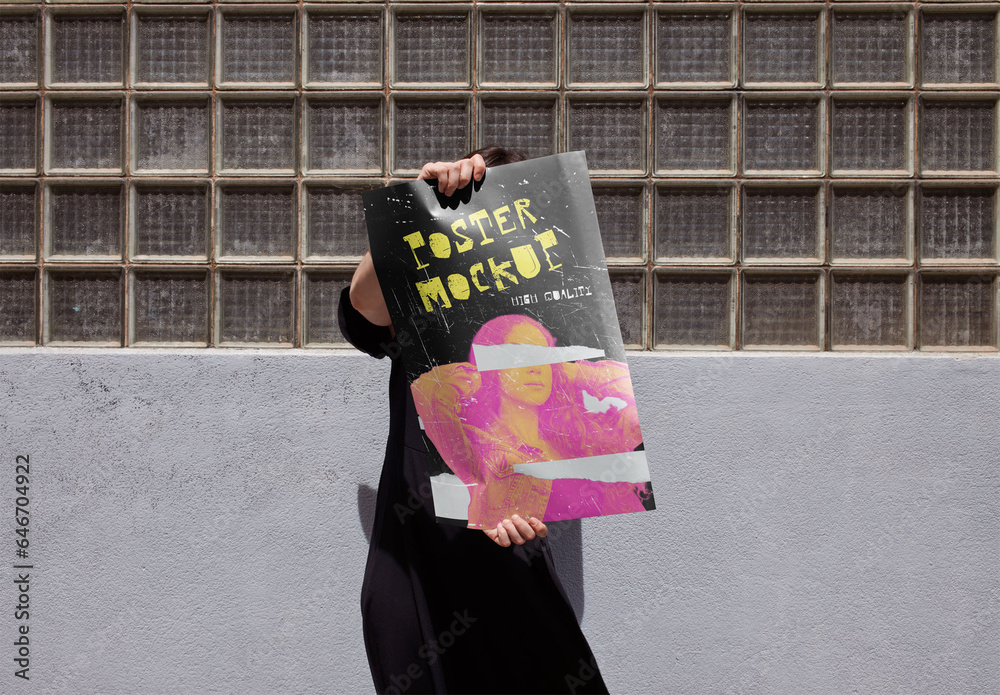 Mockup of man holding customizable A2 vertical poster in front of face ...