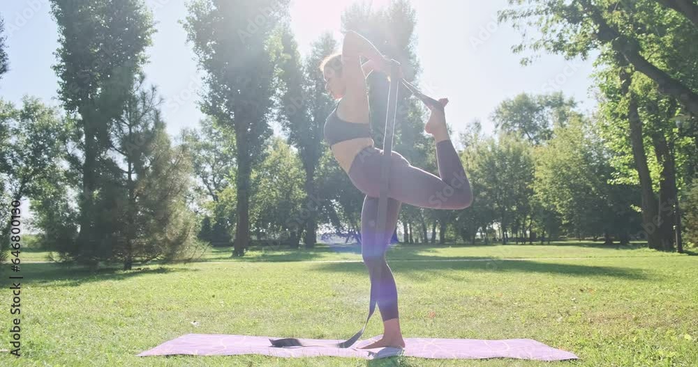 Yoga exercises with belt, dancer pose, natarajasana. Woman standing on ...