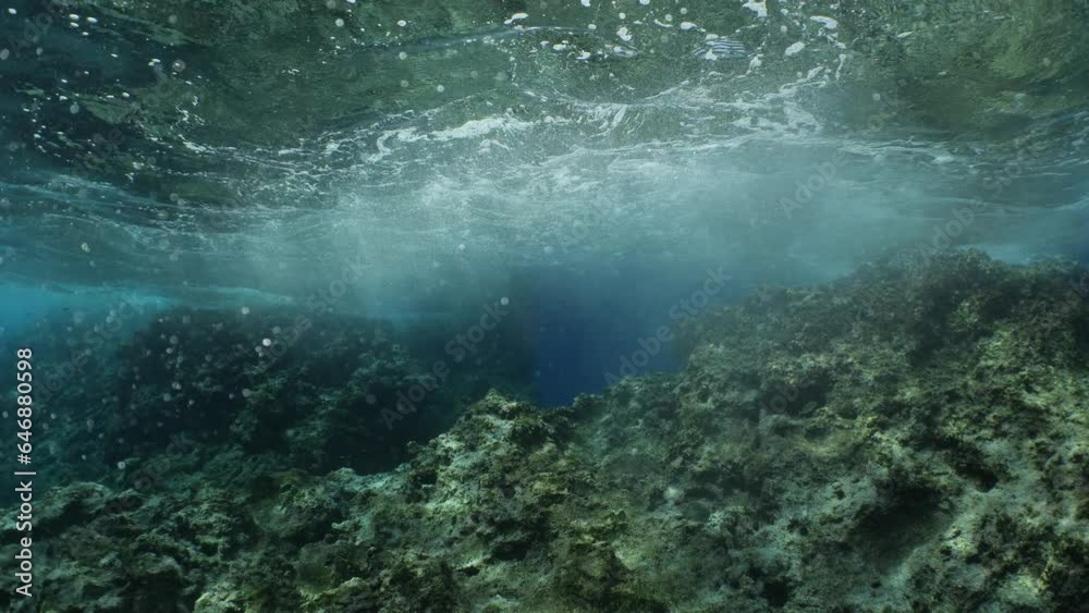 choppy water wavy sea underwater wave hit on rocks and makes foam on ...