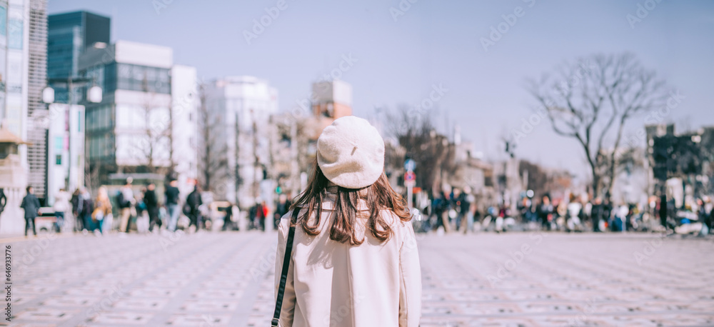 Asian girl standing out from the crowd at a city street in Japan. Stock ...