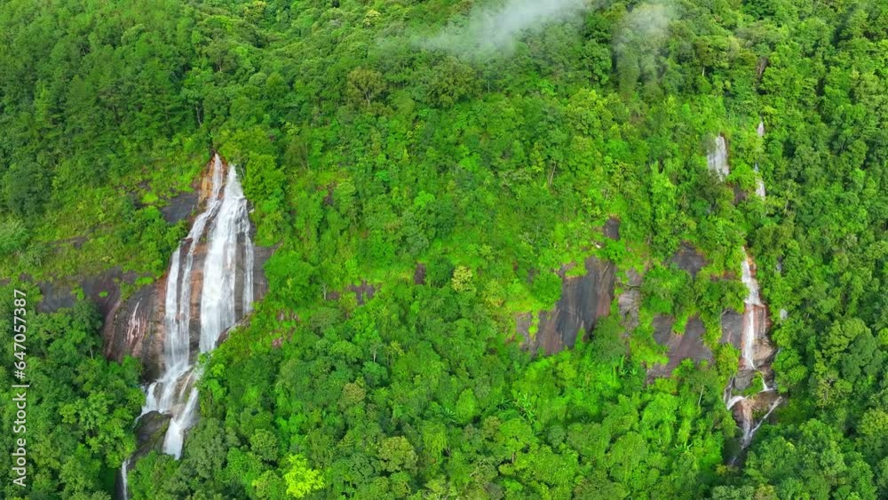 An aerial view above the waterfall. it reveals a towering cascade of ...