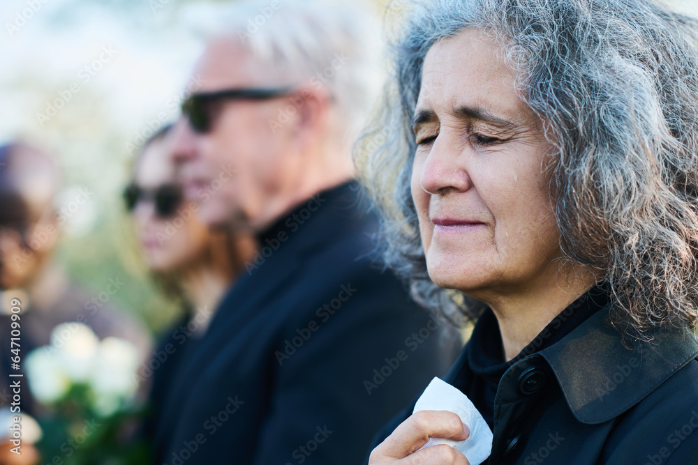 Mature crying woman with tears on her cheek lamenting her relative ...
