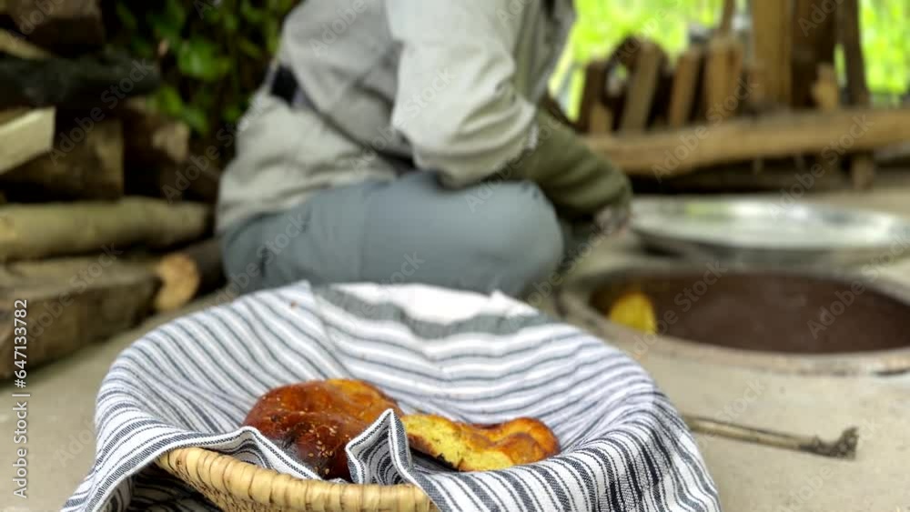 Bake hot fresh bread out of traditional clay oven in middle east Asia ...