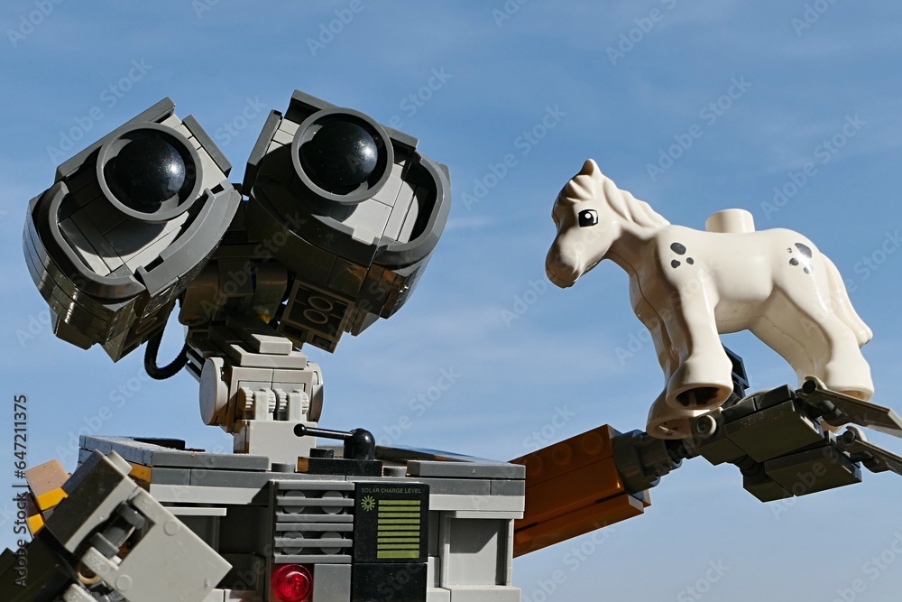 LEGO model of Wall-E robot carrying LEGO Duplo white colt with black ...