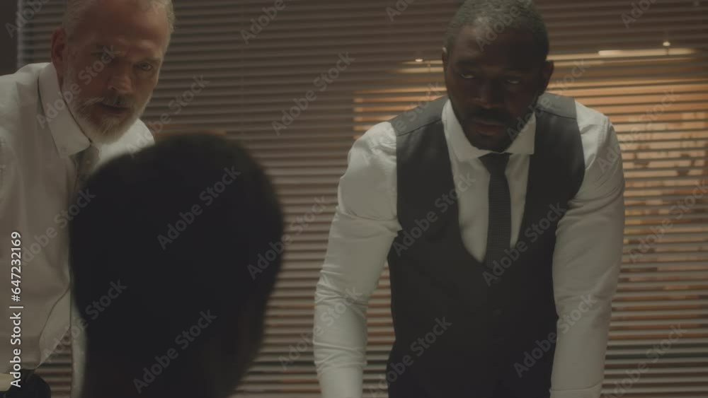 Medium shot of two diverse determined police officers pointing at crime ...