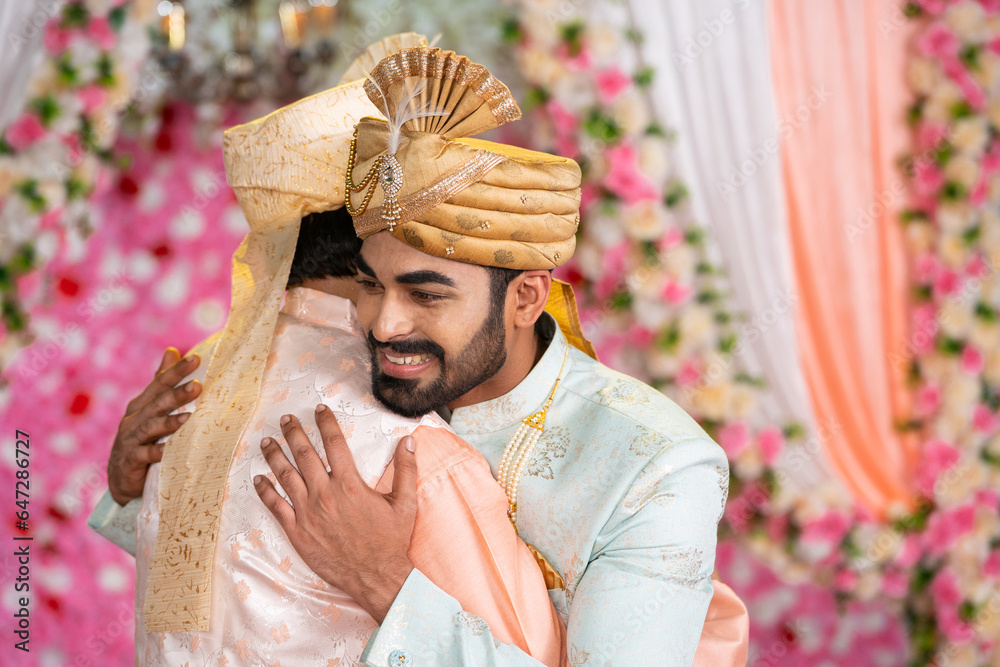 happy Indian son as groom hugging his father during Marriage or wedding ...