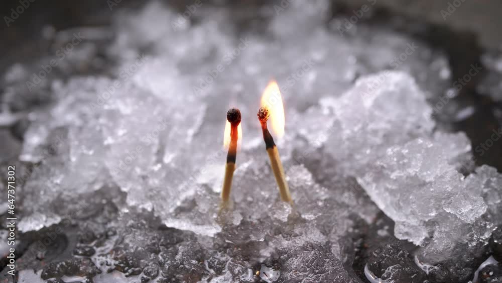 Two Matches are Burning in a Flame of Fire on Wet Snow. Burning charred ...