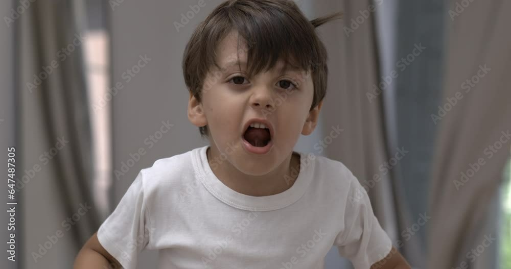 Upset child emotion in slow-motion. Close-up of angry little boy ...