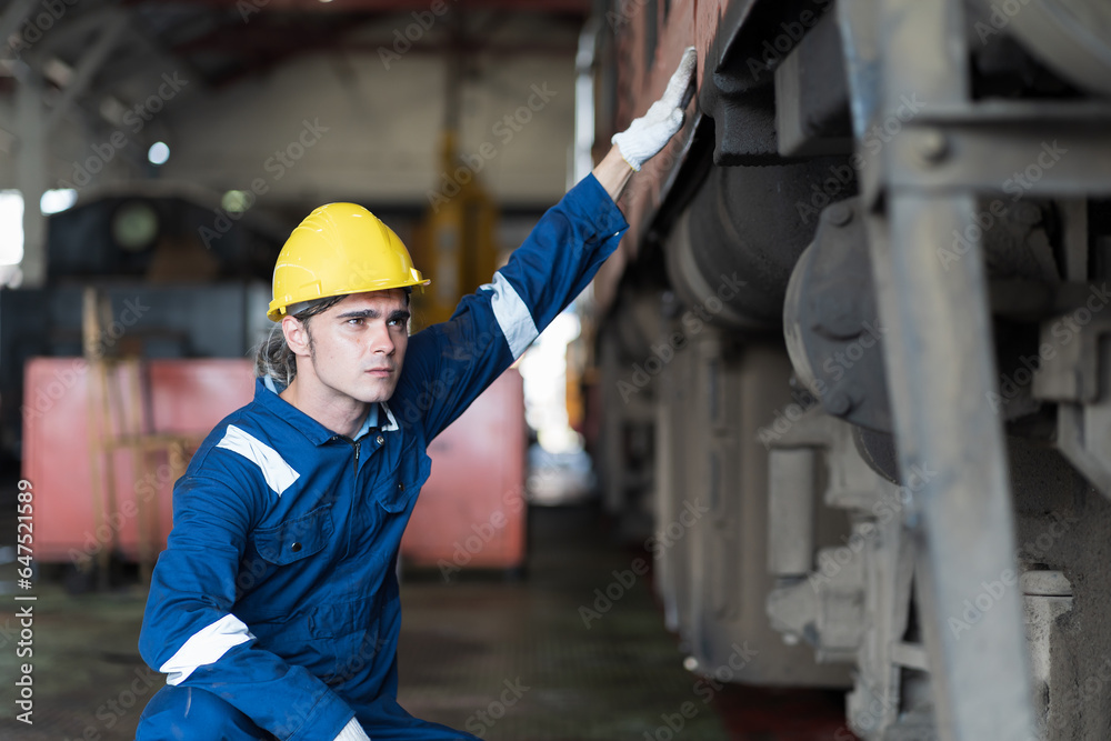 Male engineer maintenance locomotive engine, wearing safety uniform ...
