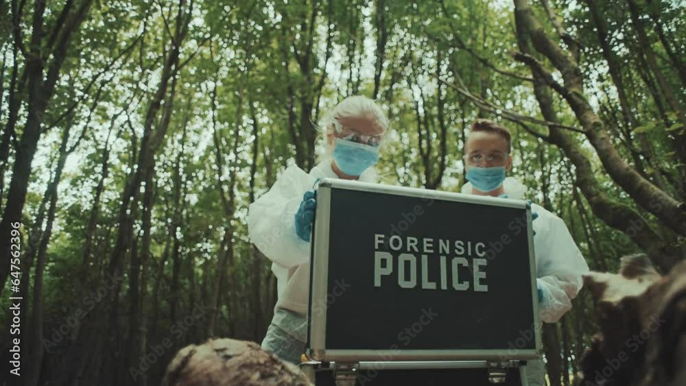 Forensic police investigators arriving at a crime scene and assessing ...