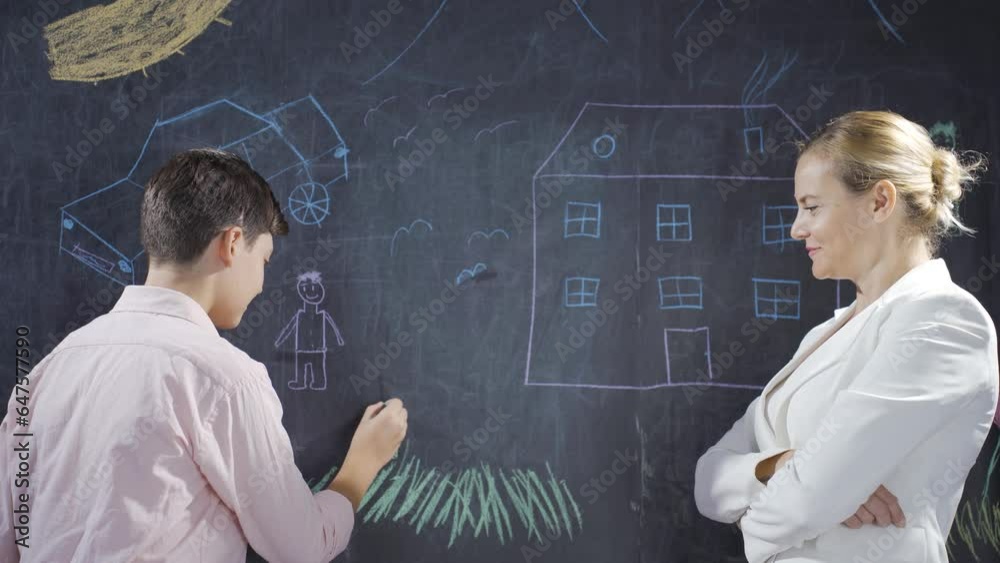 Teacher teaching her boy student how to draw a picture. Stock Video ...