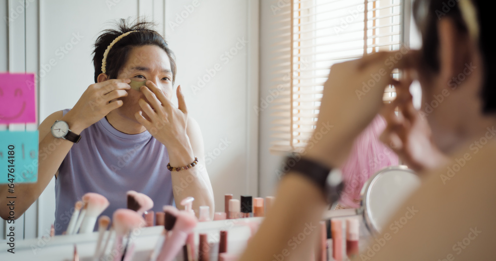 Gay queer man non-binary beauty blogger makeup artist at home cross ...