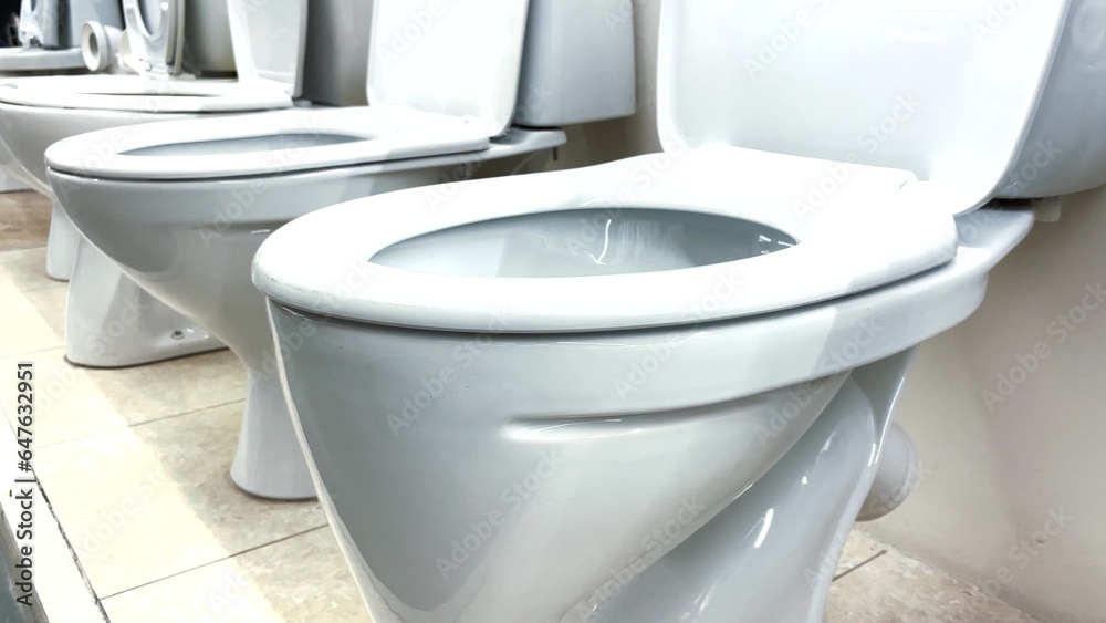 toilet in plumbing store. bathroom equipment a many toilets stand on ...