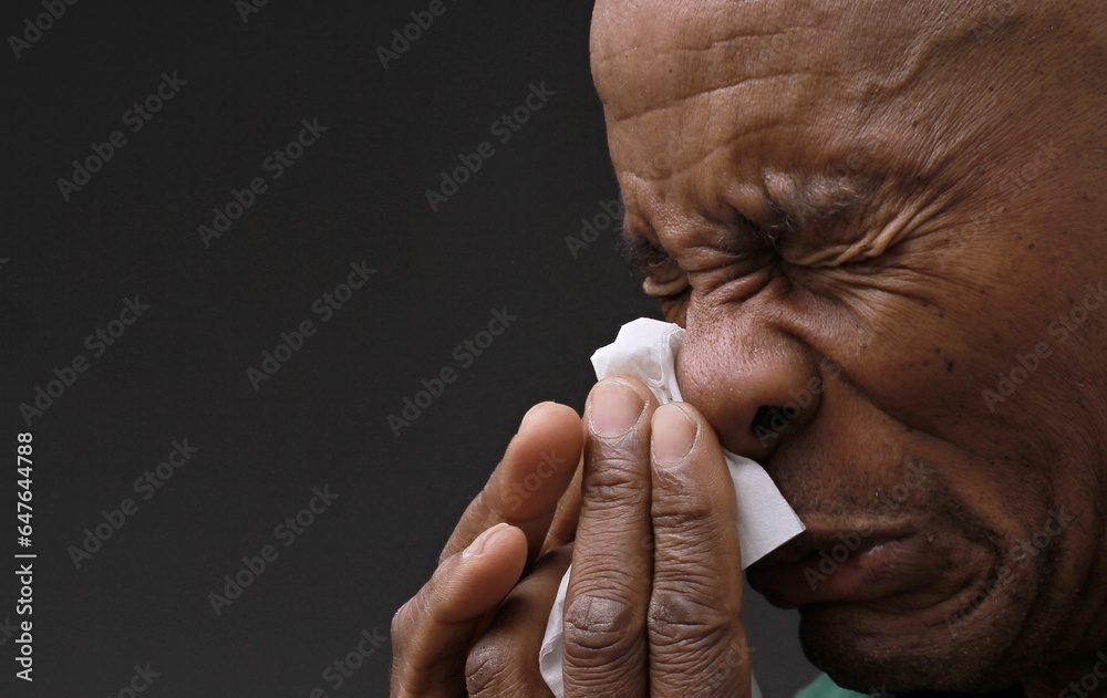 catching the cold and flu man blowing nose after catching a cold with ...