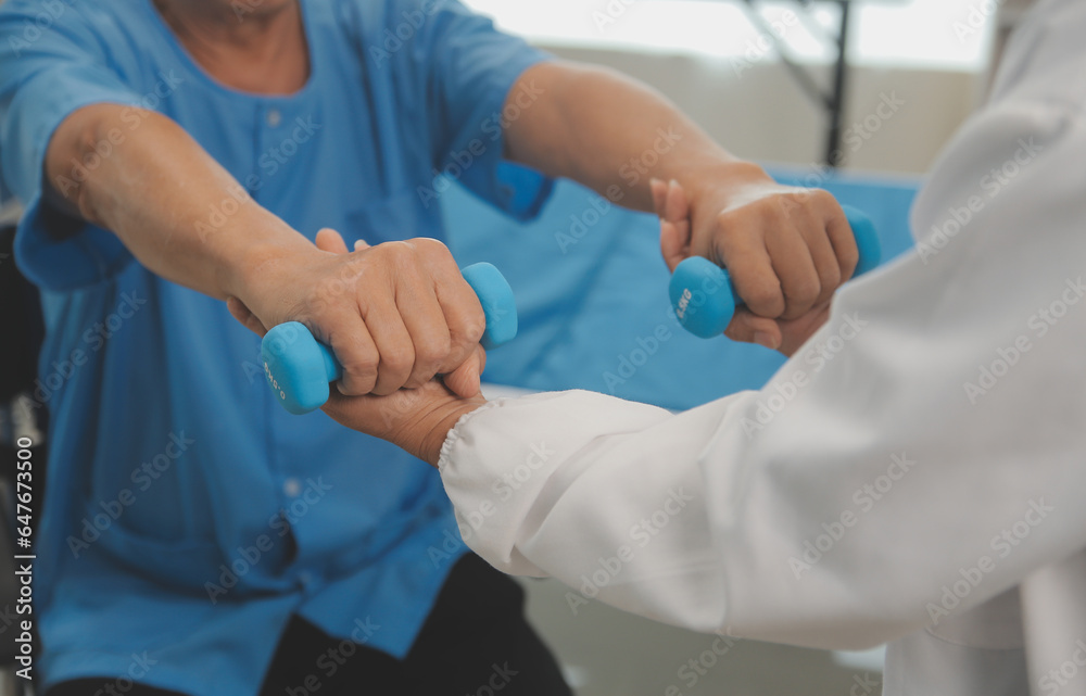 Asian older aged man doing physiotherapist with support from nurse ...