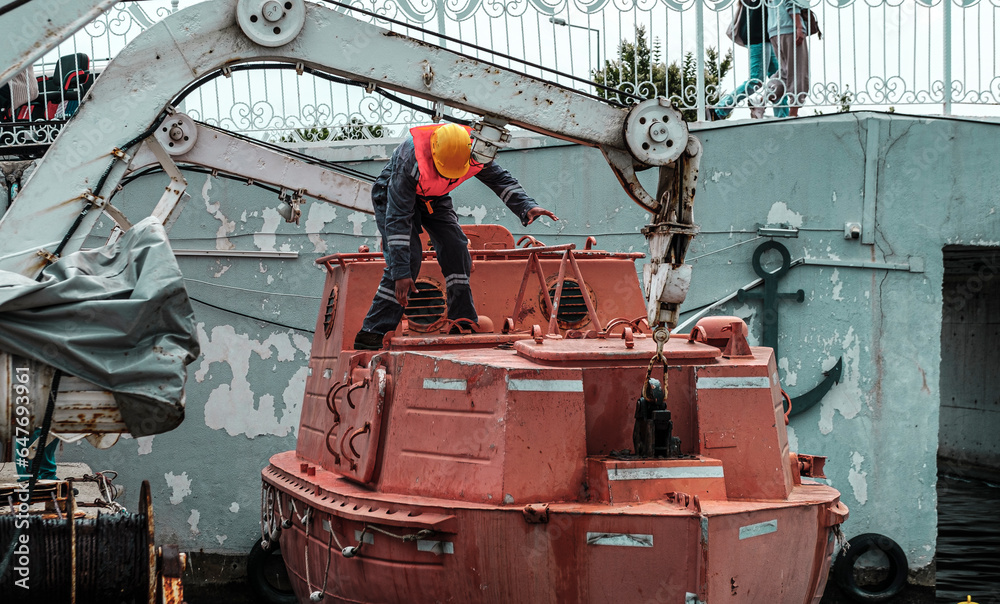 davit launched liferaft onshore, old rusty ship lifeboat, resque ...