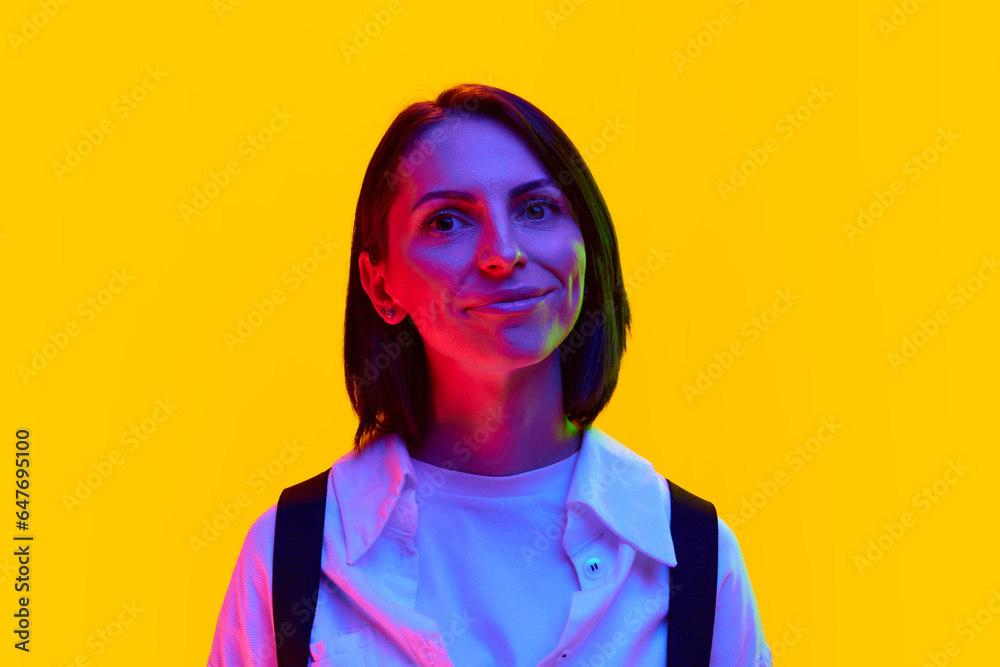 Portrait of elegant woman in her 30s wearing white shirt, looking with ...