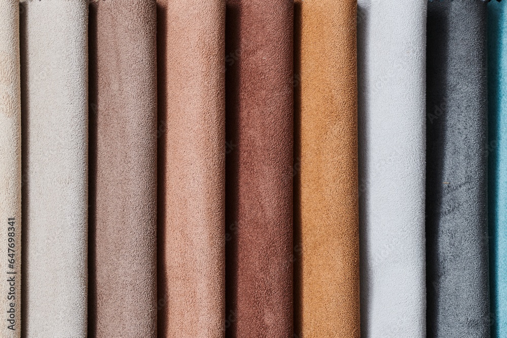 Colorful samples of upholstery fabrics close-up. Leather and suede for ...