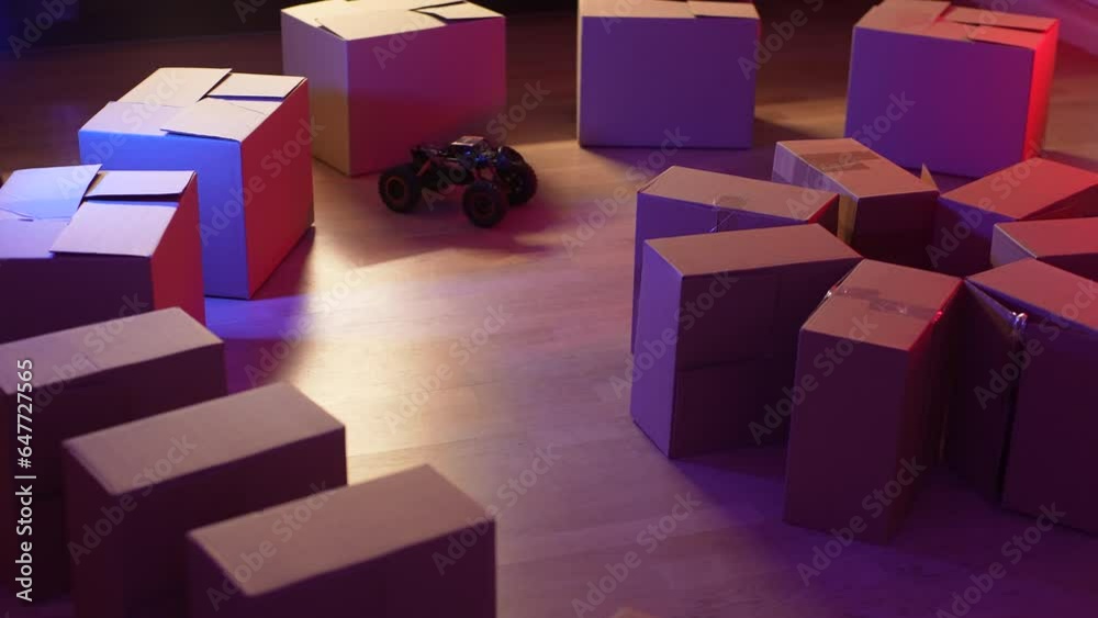 Top view of radio-controlled toy car drives through improvised ...