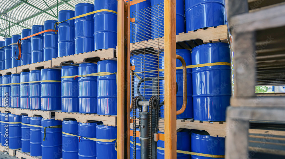 Chemical storage tanks neatly stored on wooden pallets in Warehouse ...