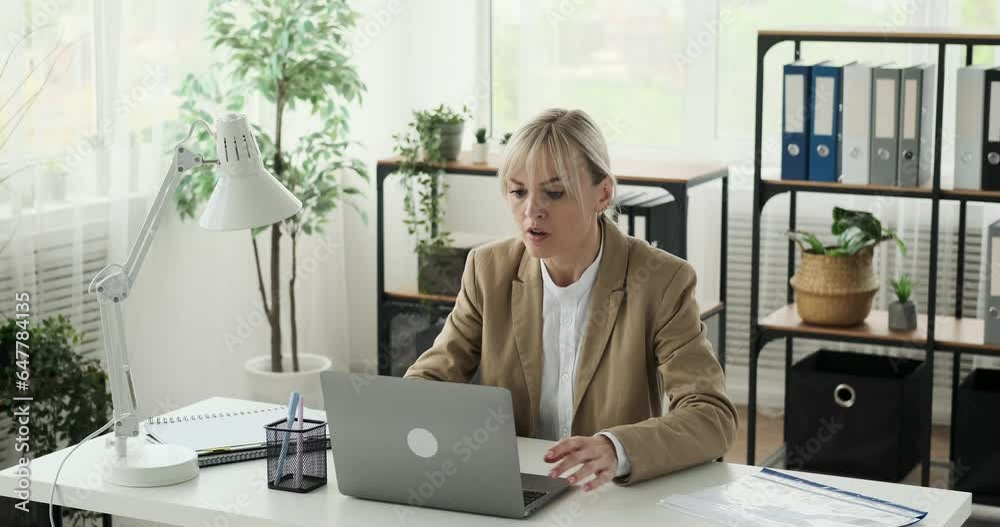 An angry woman office worker is seen getting frustrated and upset ...