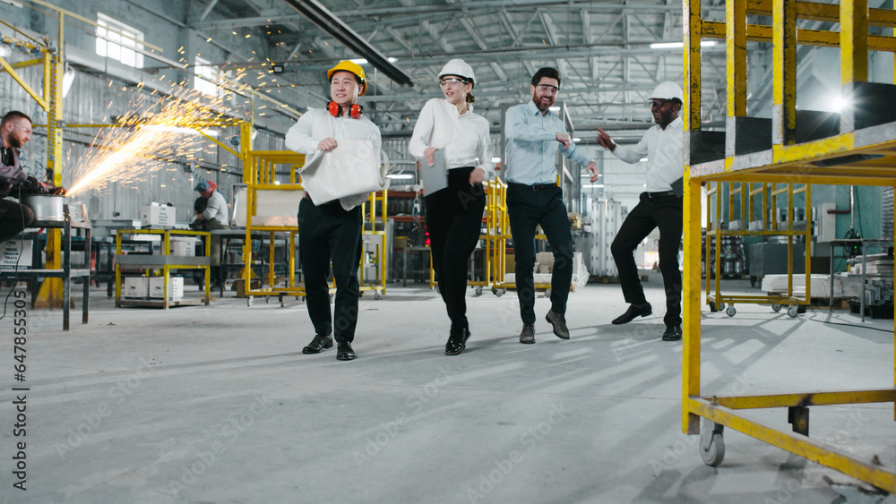 Group of construction engineers having fun and dancing on construction site. Multicultural ...